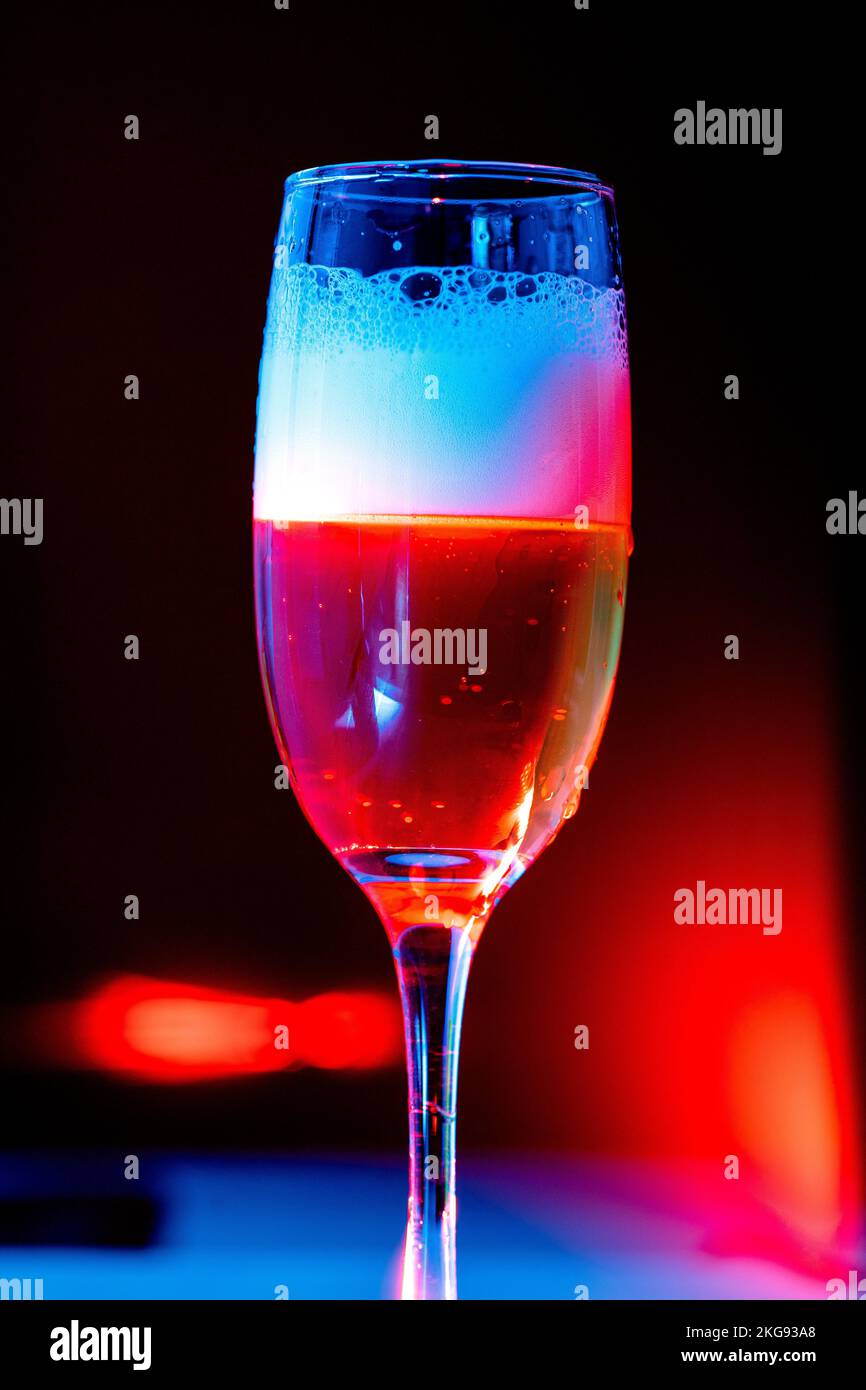 A vertical image of a glass of Champaign in the dark background with ...