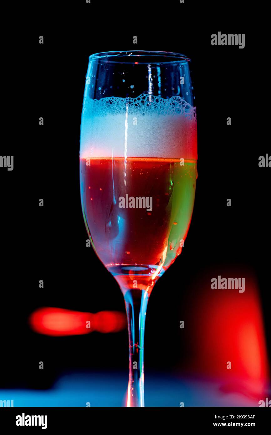 A vertical image of a glass of Champaign in the dark background with ...
