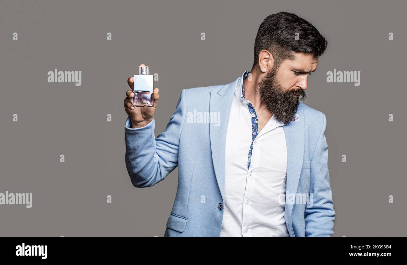 Masculine perfume, bearded man in a suit. Perfume or cologne bottle and ...
