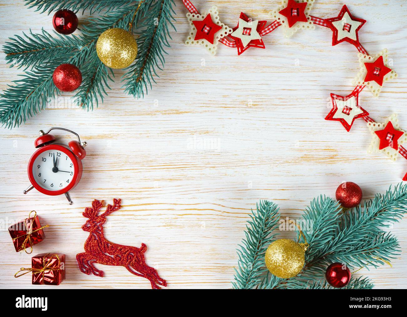 Decorated Christmas and New Year tree, toy deer, garland and clock on ...