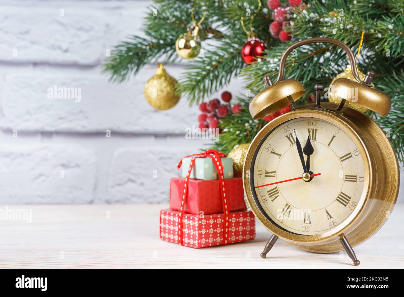 Christmas tree and countdown to the new year. Bronze retro clock, gift ...