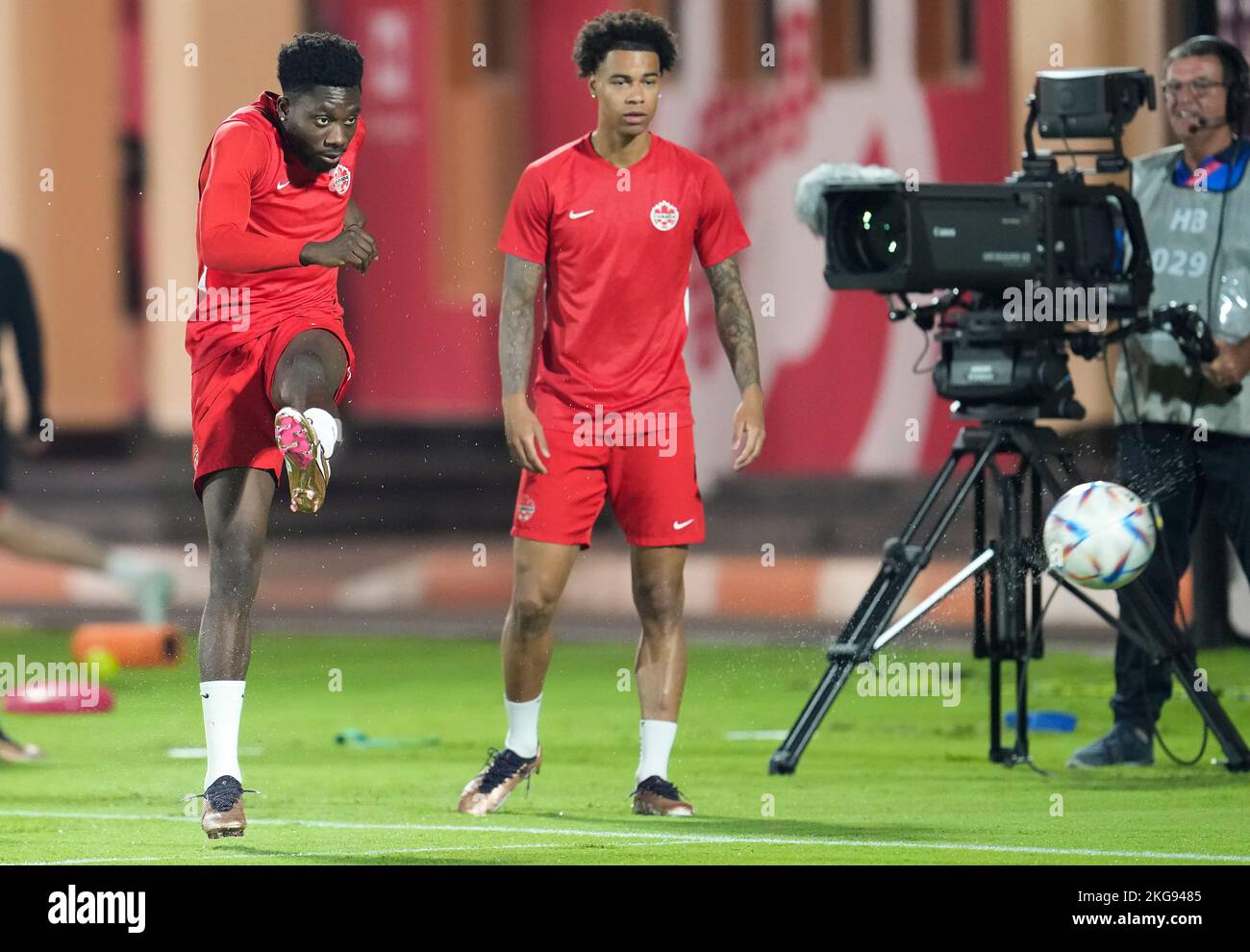 Doha, Qatar, Nov. 22, 2022. Canada forward Alphonso Davies, left, kicks ...