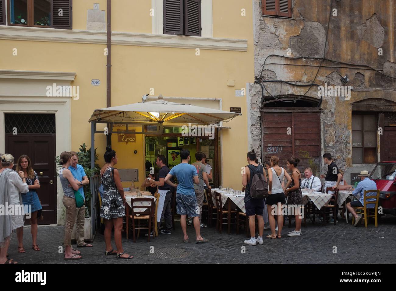 People outside Da Enzo Al 29, a popular local restaurant along a ...