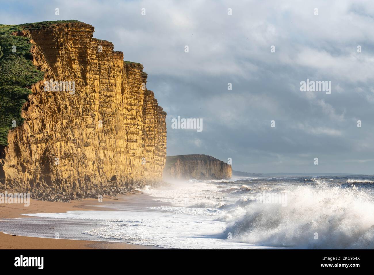 A view of the dramatic sunlit cliffs at West Bay, Dorset, UK Stock Photo - Alamy