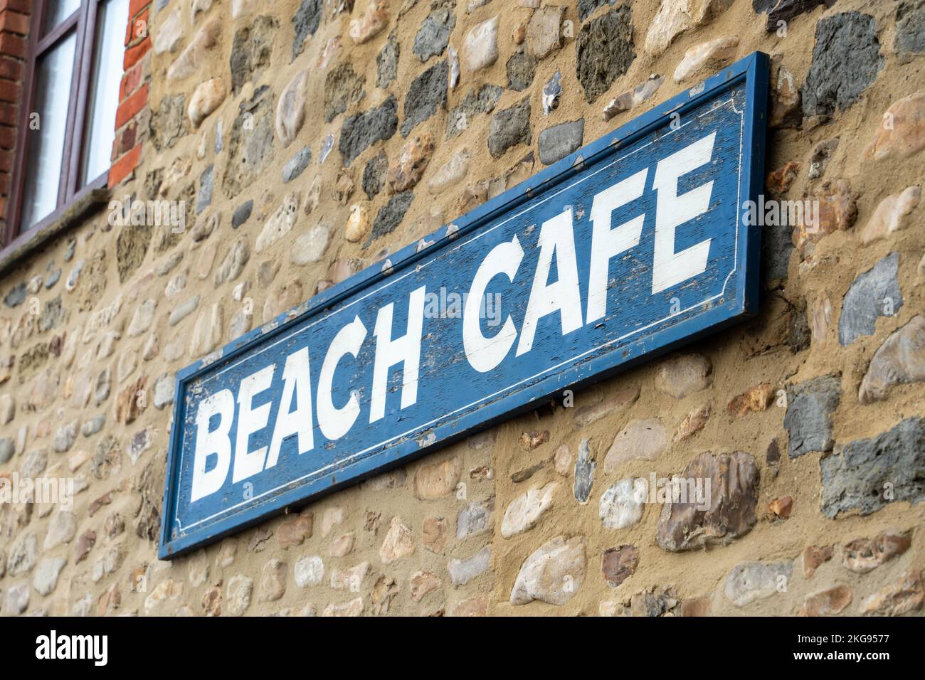 A blue wooden sign with white writing, reading 'Beach Cafe' on a ...
