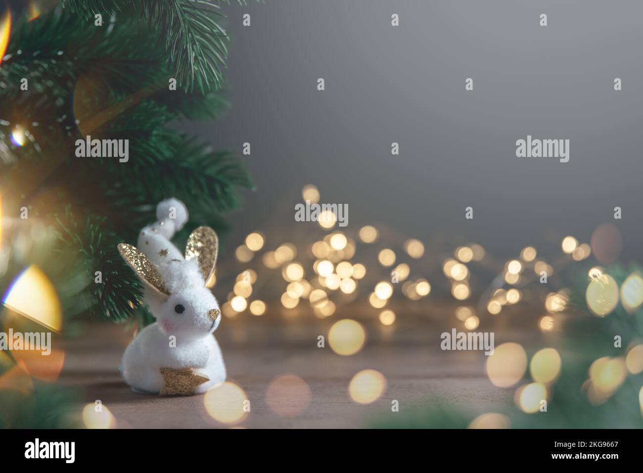 a rabbit symbol of 2023 among the lights, garlands, Christmas trees ...