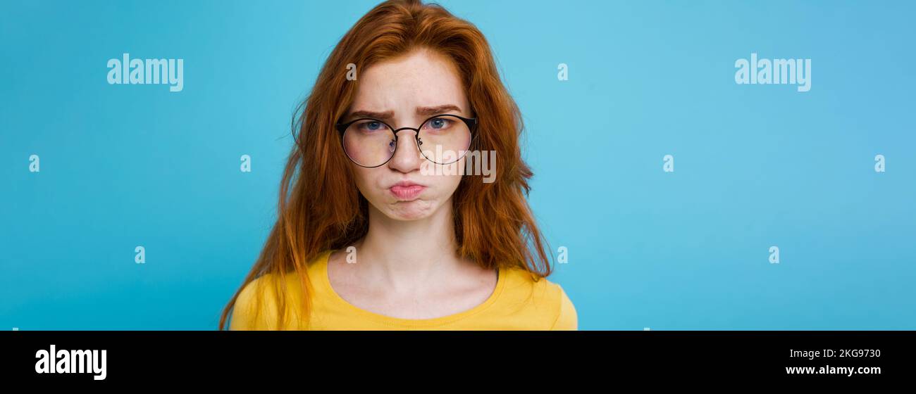 Headshot Portrait of tender redhead teenage girl with serious ...