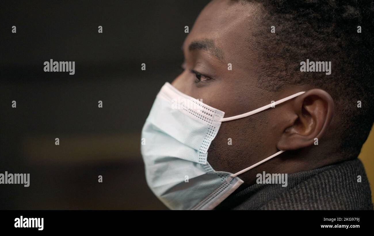 Profile of black African man wearing covid-19 face mask inside subway ...