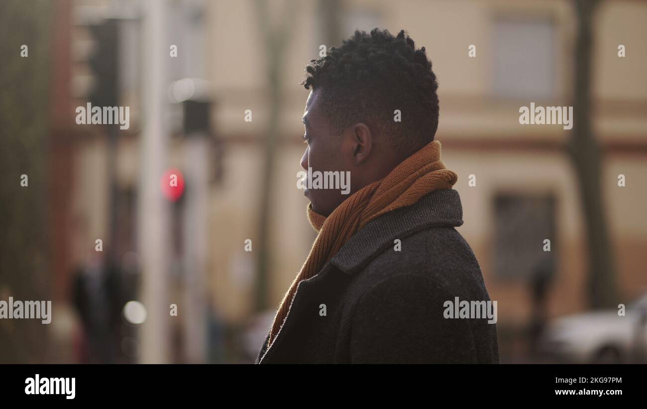 Tearful Sad Black man standing outside in city feeling alone Stock ...