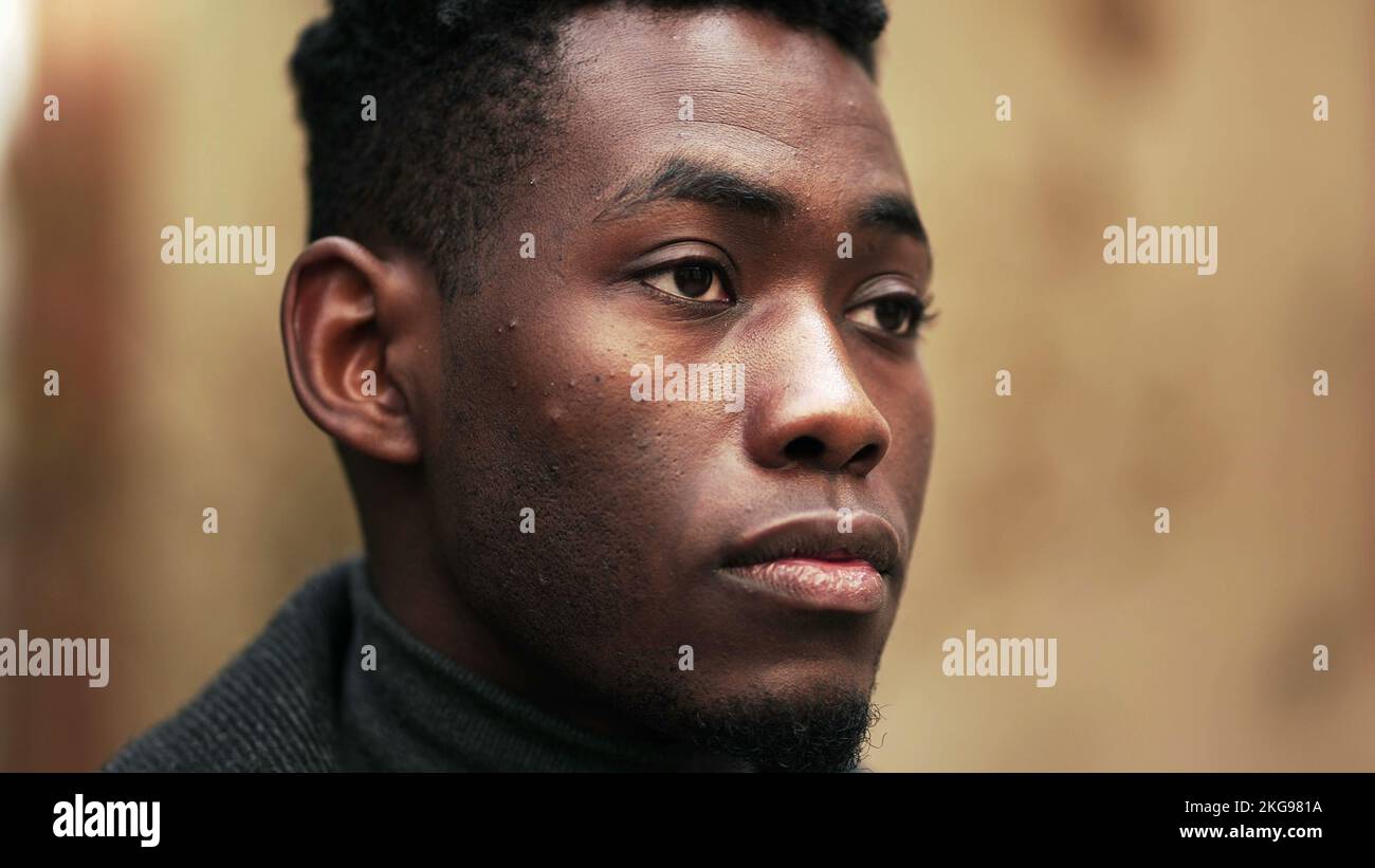Serious young black African man no emotion expression staring camera, tracking face shot Stock ...