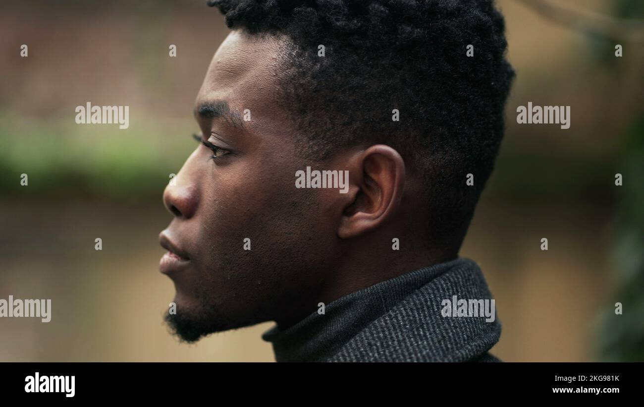 Serious young black African man no emotion expression staring camera ...