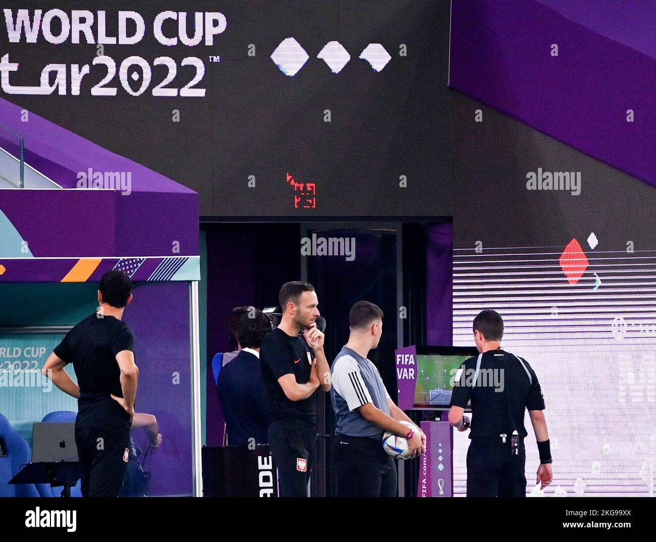Doha, Qatar. 22nd Nov, 2022. Referee Chris Beath (1st R) views the VAR ...
