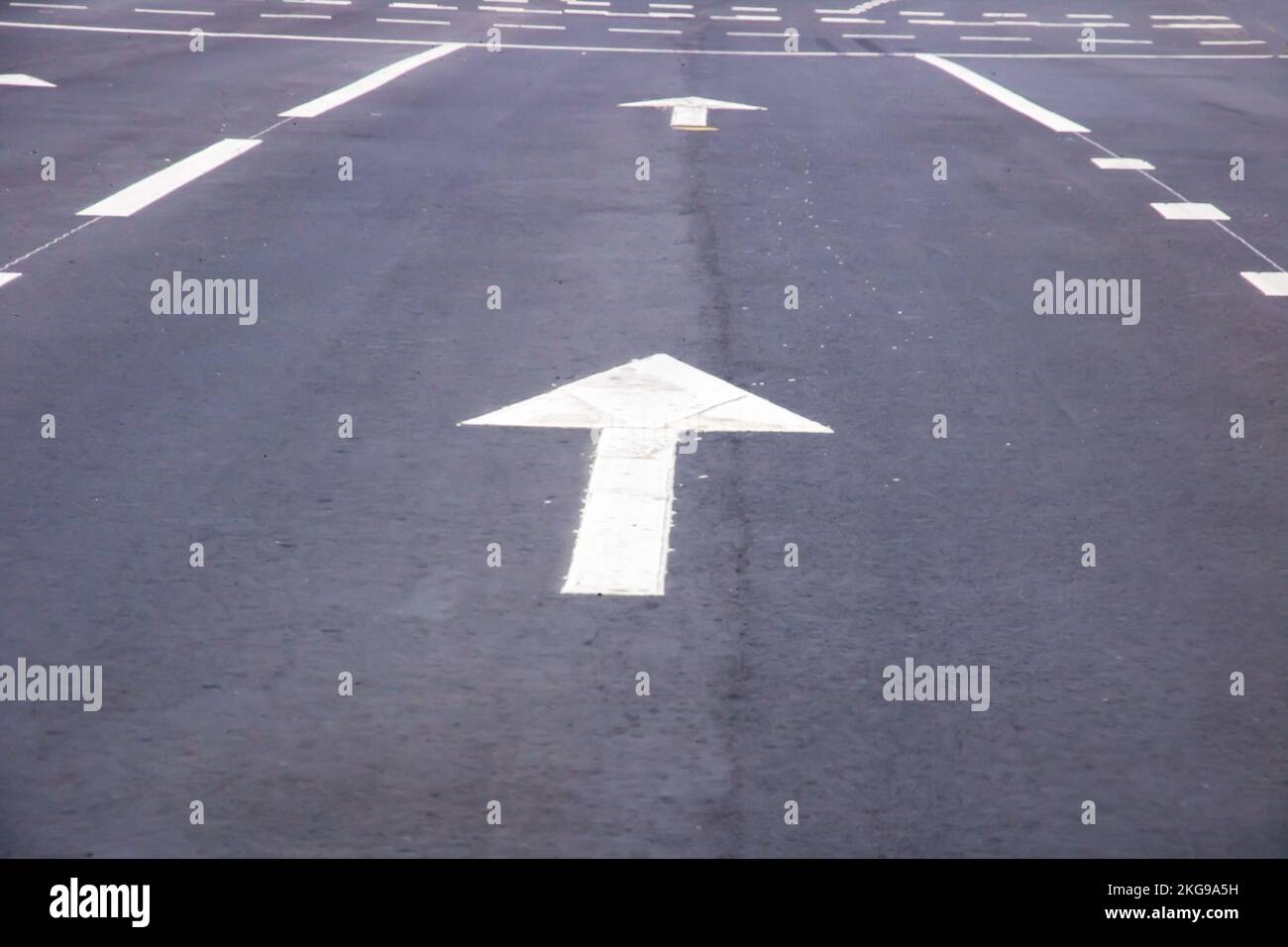 Markings on the road arrow forward close up Stock Photo - Alamy