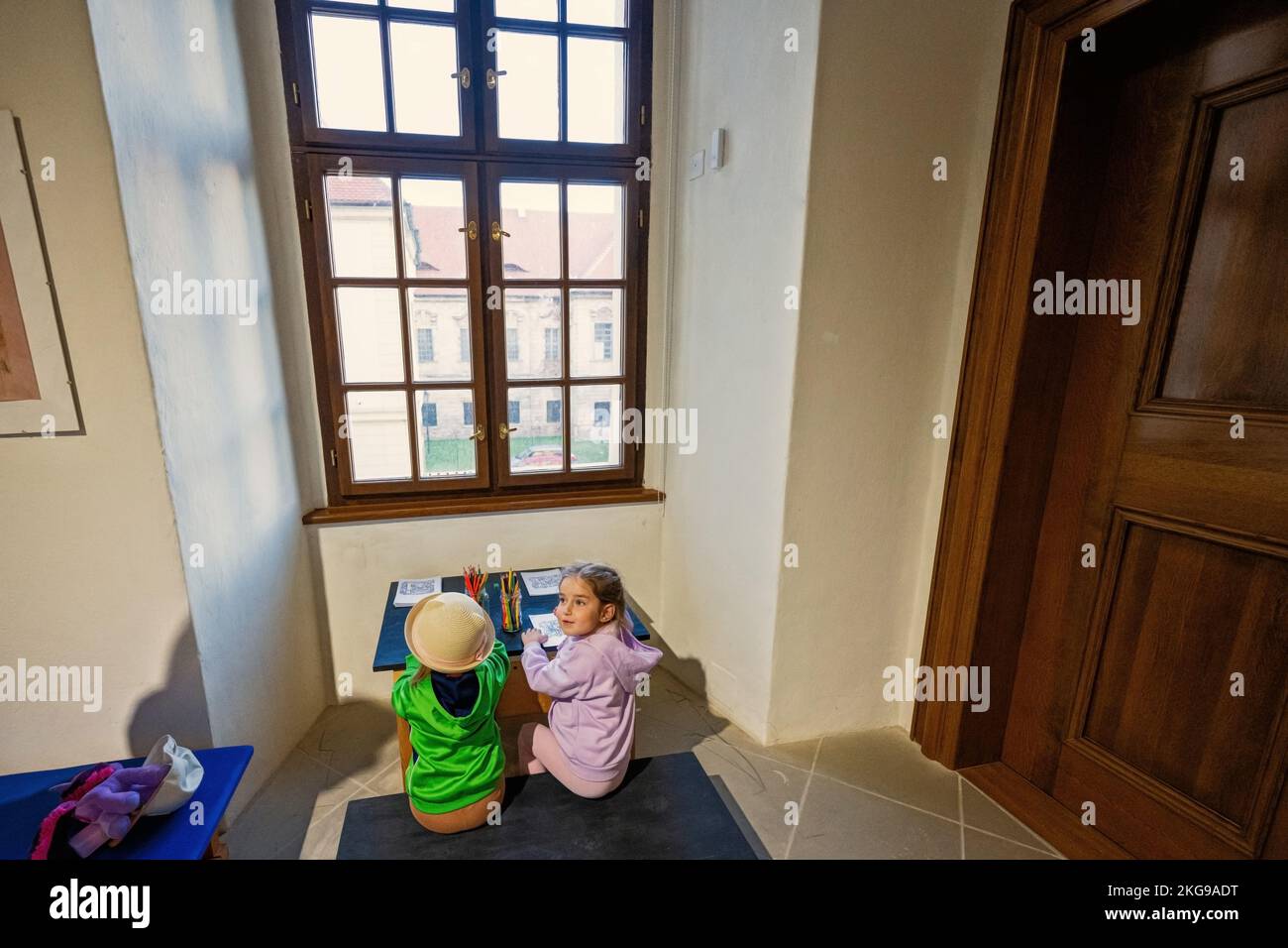 Two sisters sit at the table opposite window and draw Stock Photo - Alamy