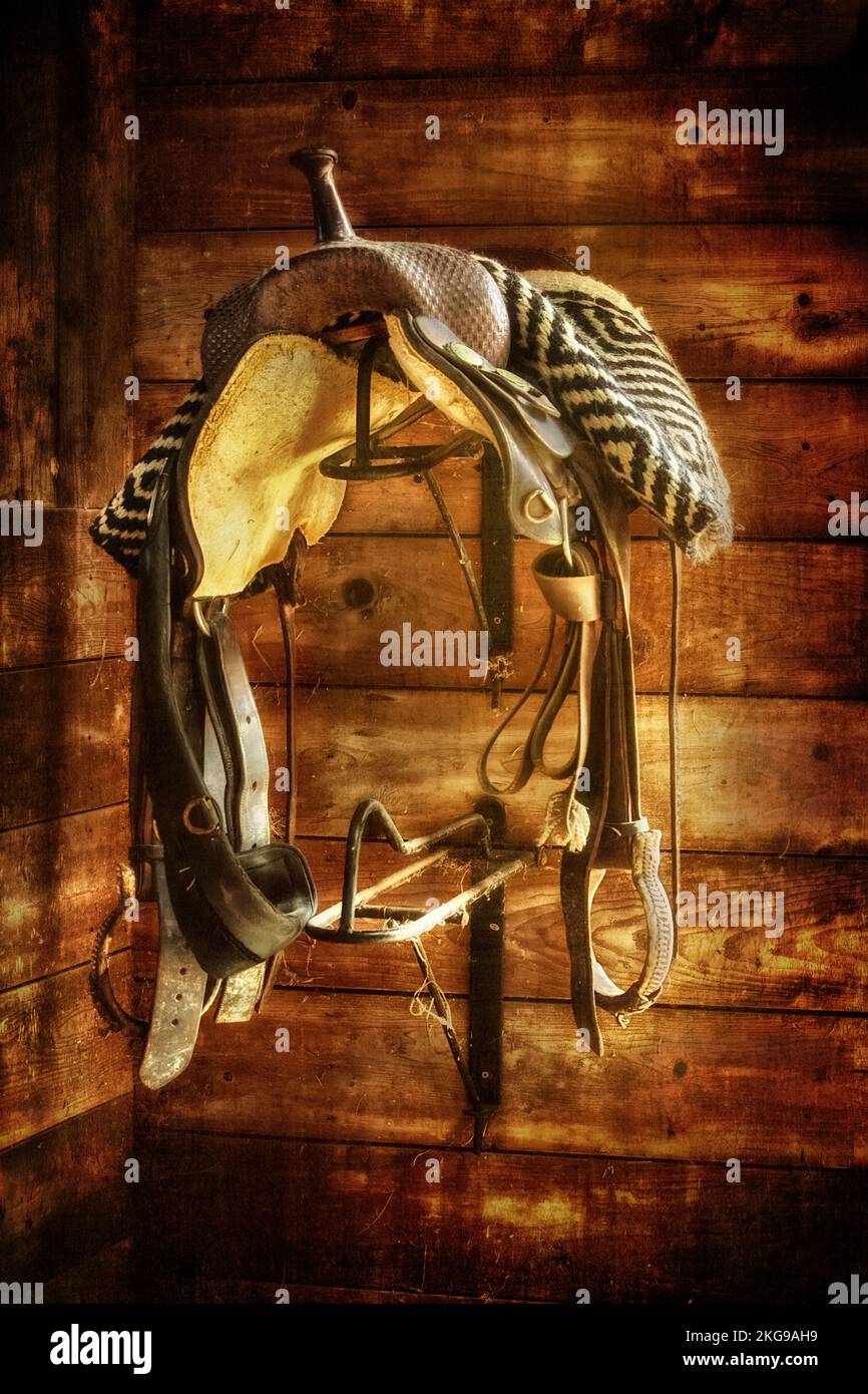 Western style saddle on a saddle rack in a barn Stock Photo - Alamy