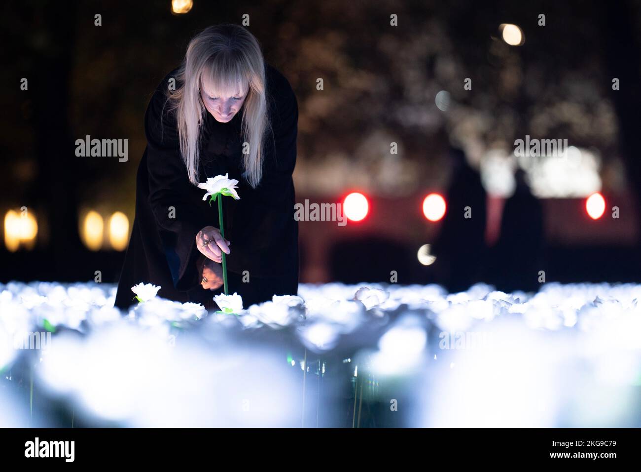 A person dedicates a rose in memory of a loved one, at Royal Marsden's ...