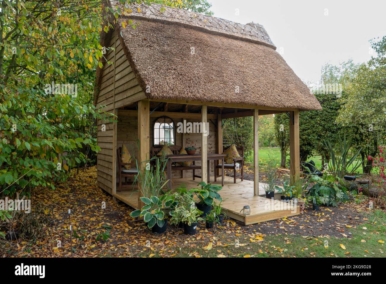 Thatched roof grden gazebo in the uk Stock Photo - Alamy
