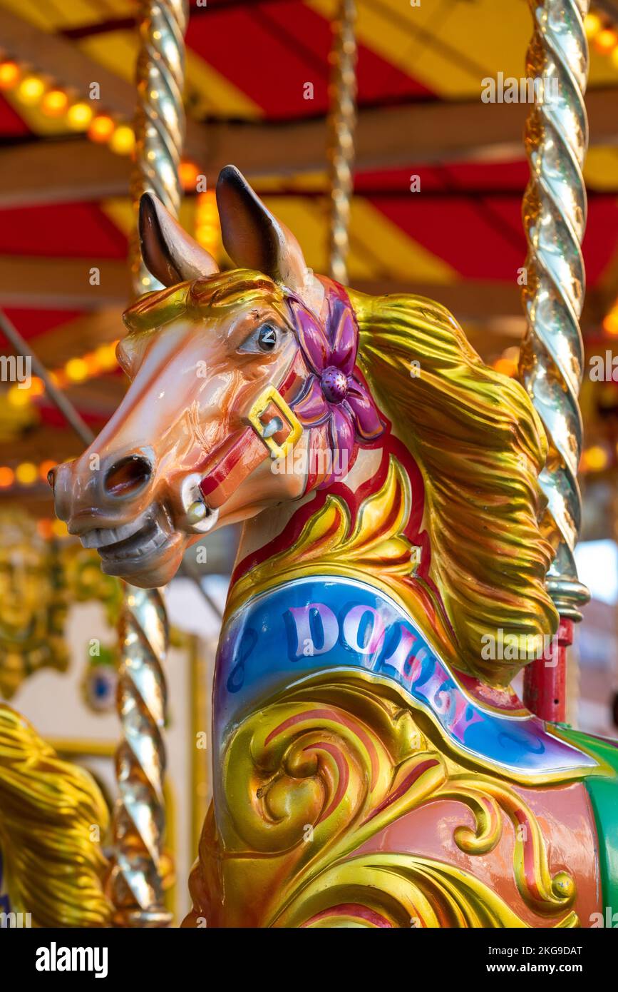 The bright and vibrant colours of the horses on a funfair carousel ...
