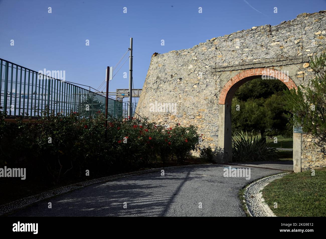 Path going through an arch of an ancient bounday wall in a park Stock ...