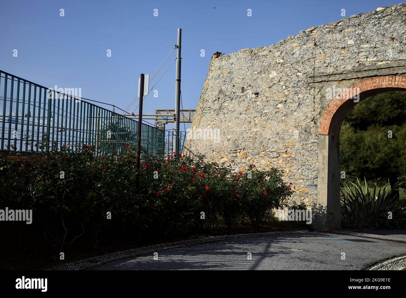 Path going through an arch of an ancient bounday wall in a park Stock ...