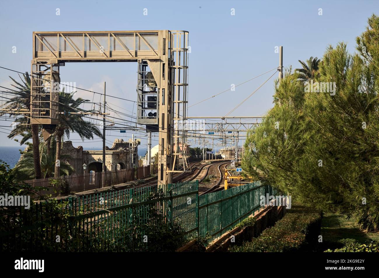 Railroad tracks next to a cliff by the sea on a sunny day Stock Photo ...