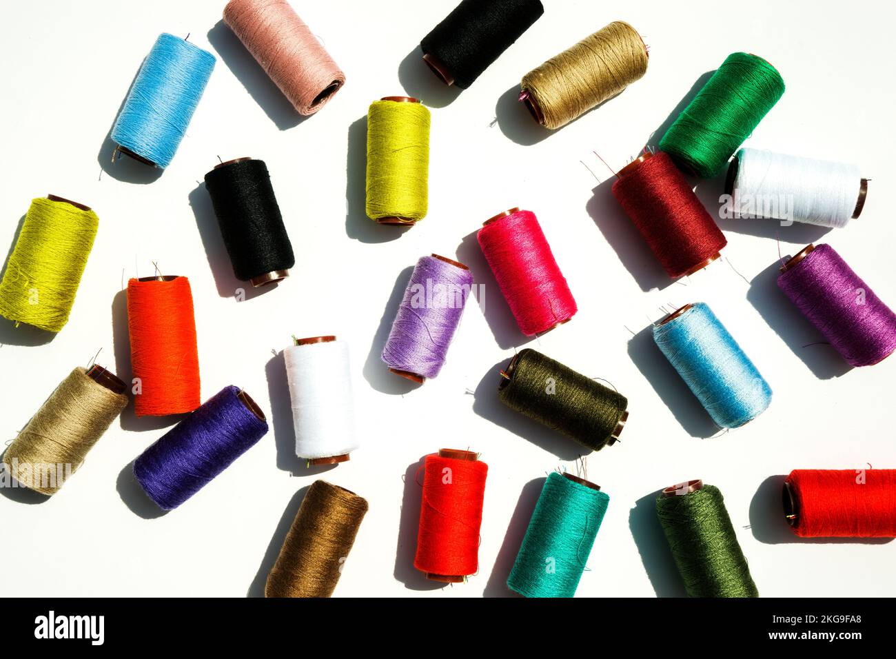 Multi-color silk thread coils on white background Stock Photo - Alamy