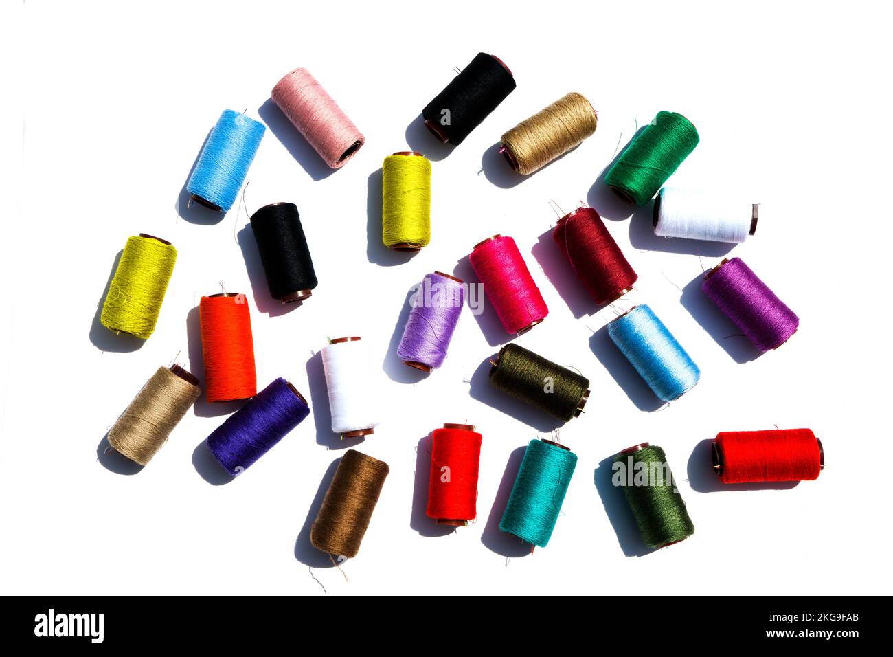 Multi-color silk thread coils on white background Stock Photo - Alamy