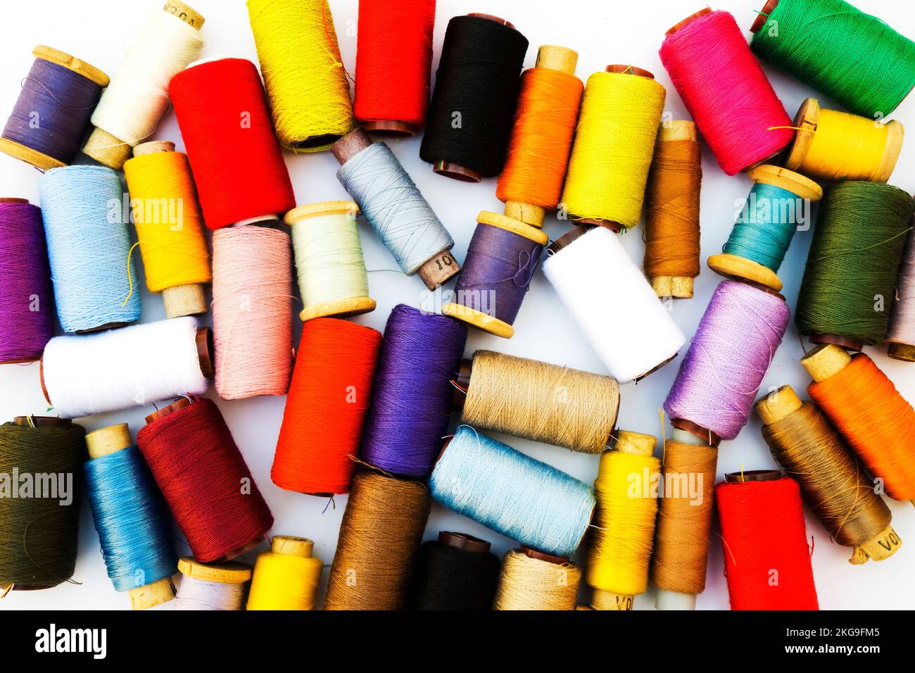 Multi-color silk thread coils on white background Stock Photo - Alamy