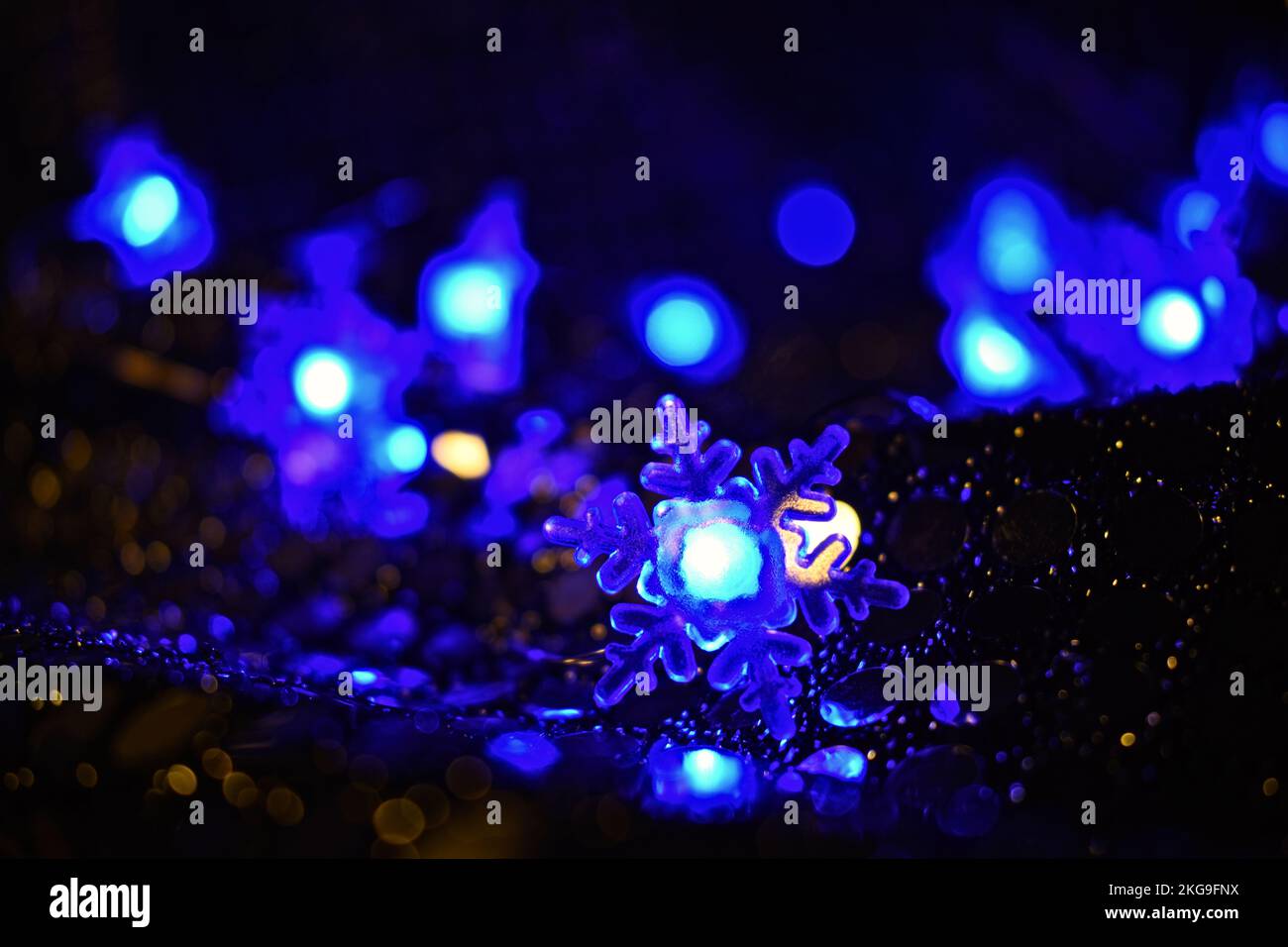 The close-up view of Christmas blue lights shining in the darkness ... The close-up view of Christmas blue lights shining in the darkness ...