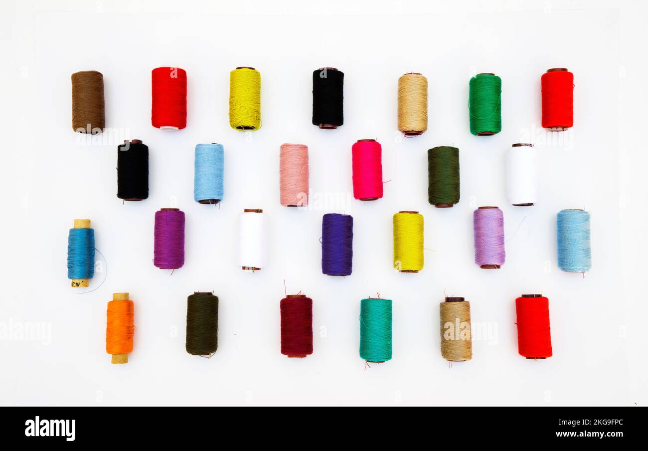 Multi-color silk thread coils on white background Stock Photo - Alamy