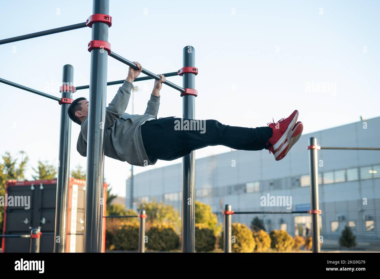 Young caucasian man doing parallel bars exercise outdoors Stock Photo - Alamy