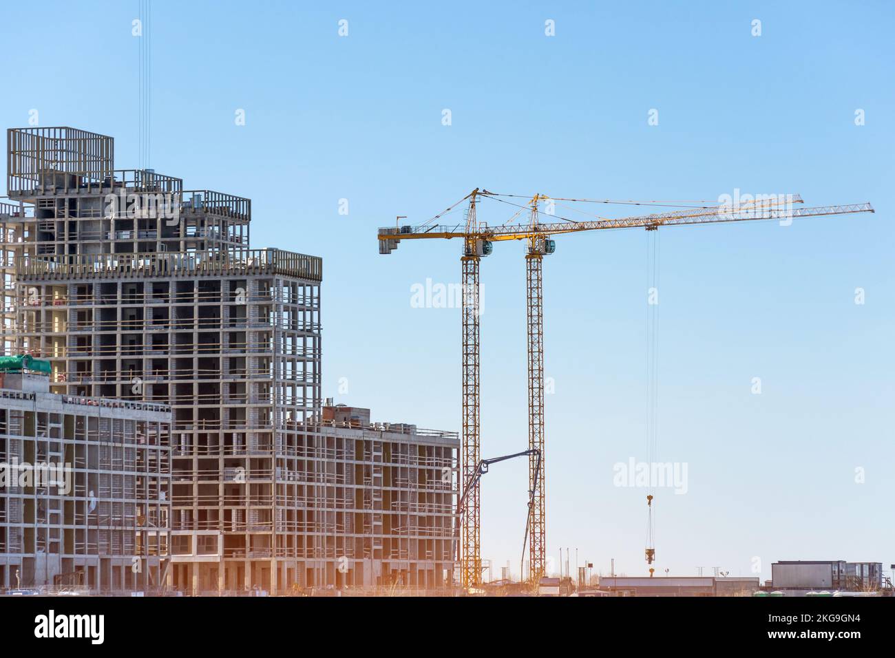 View of a residential complex under construction with high cranes ...
