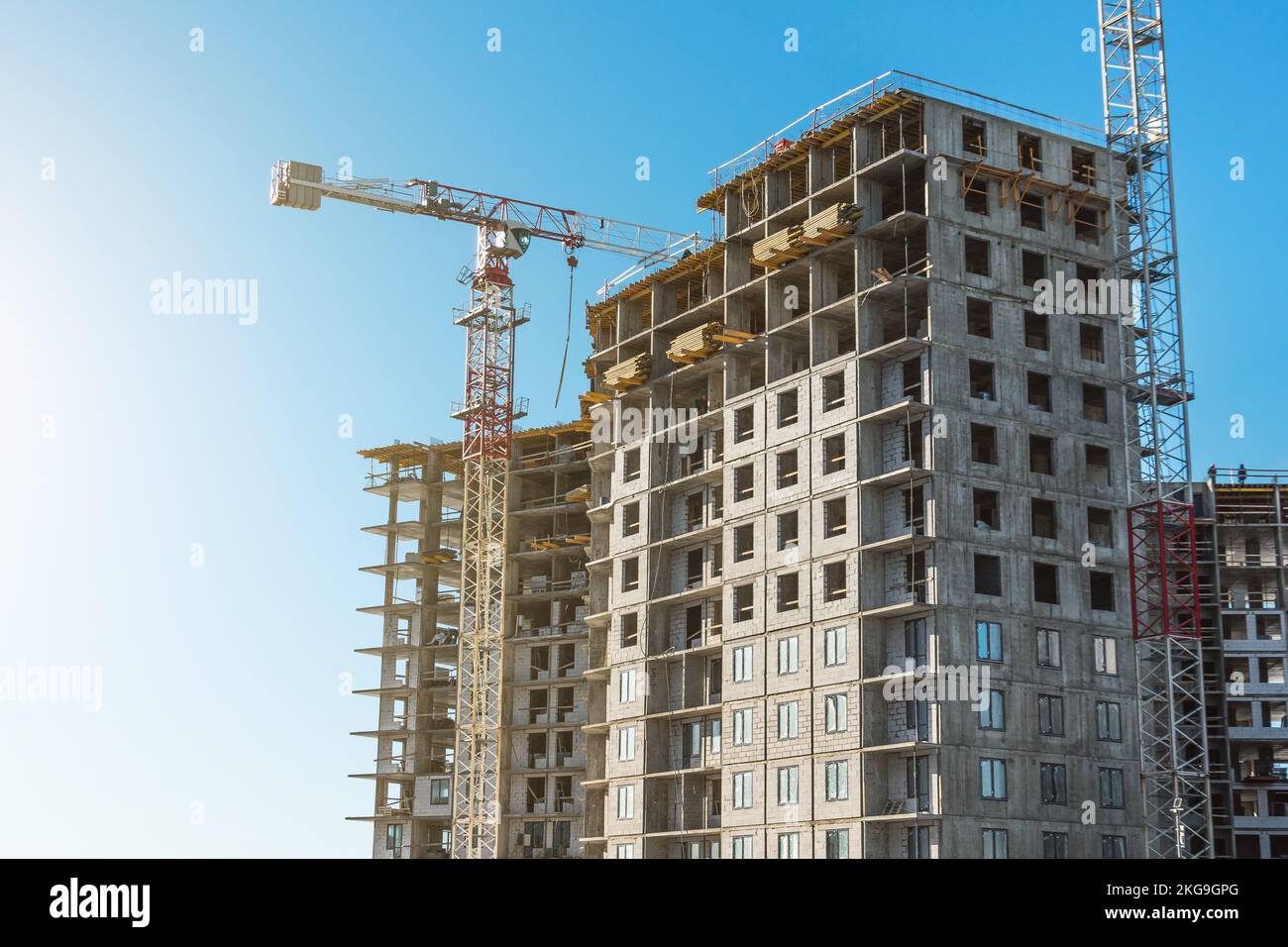 Crane and high-rise residential building. Real Estate Construction ...