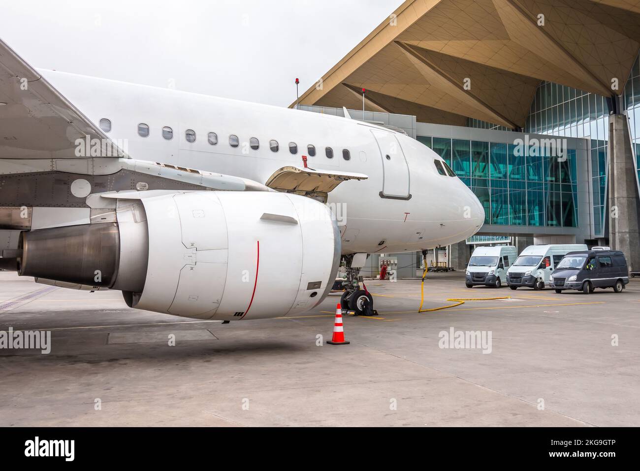 Commercial passenger airplane in the parking at the airport terminal ...