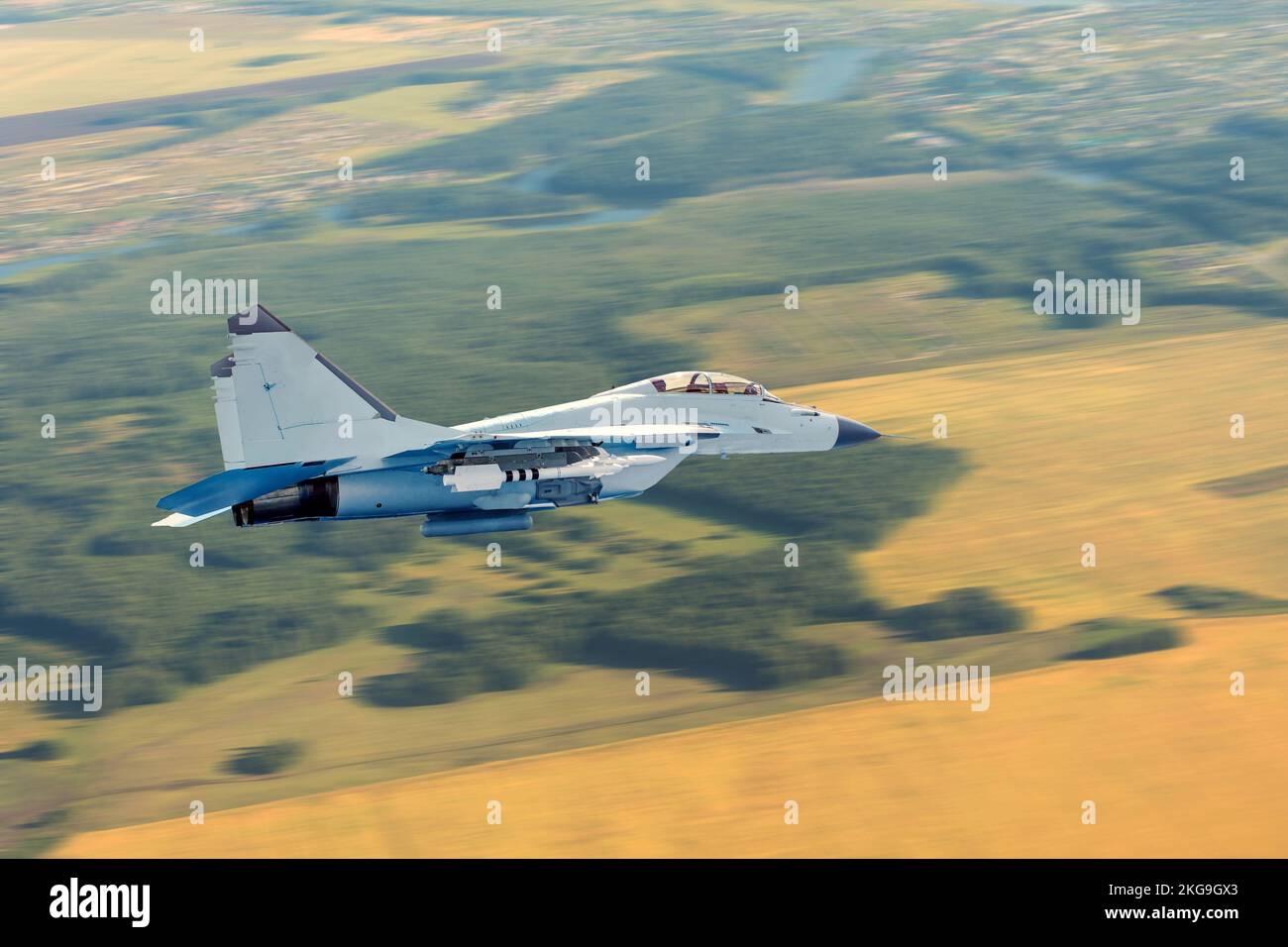 Military fighter jet against flies over the territory Stock Photo - Alamy