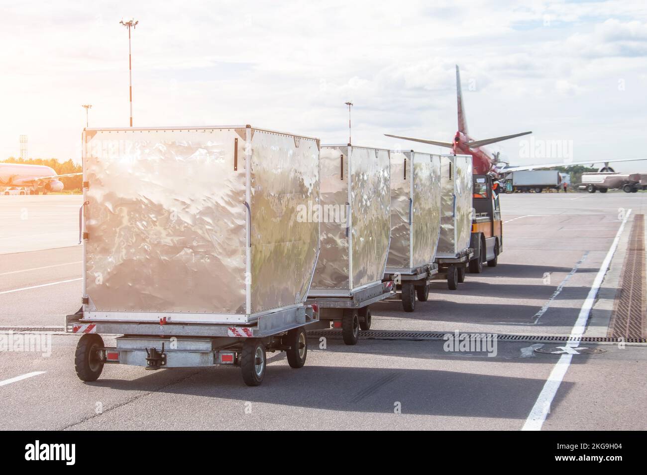 Trailers with containers of onboard aviation food for loading into a ...