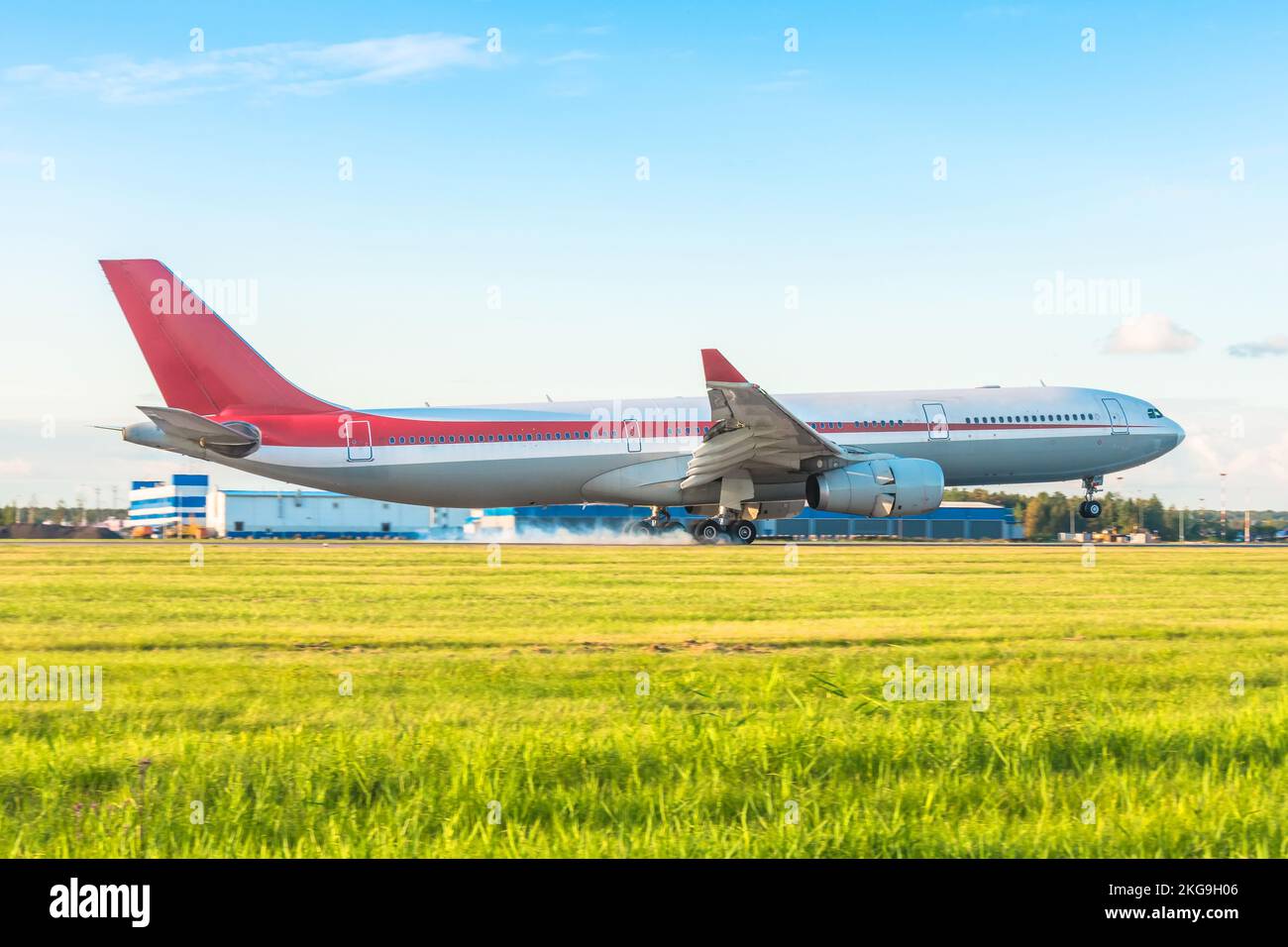 Airliner touching down on runway whith wheel rubber smoke Stock Photo ...