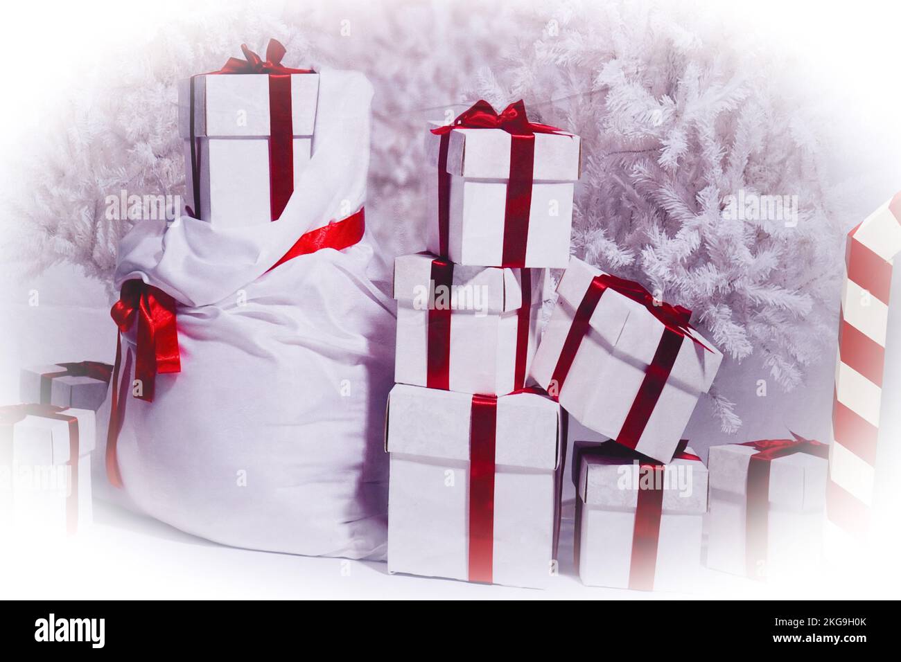 white and red Christmas presents with winter background with trees and ...