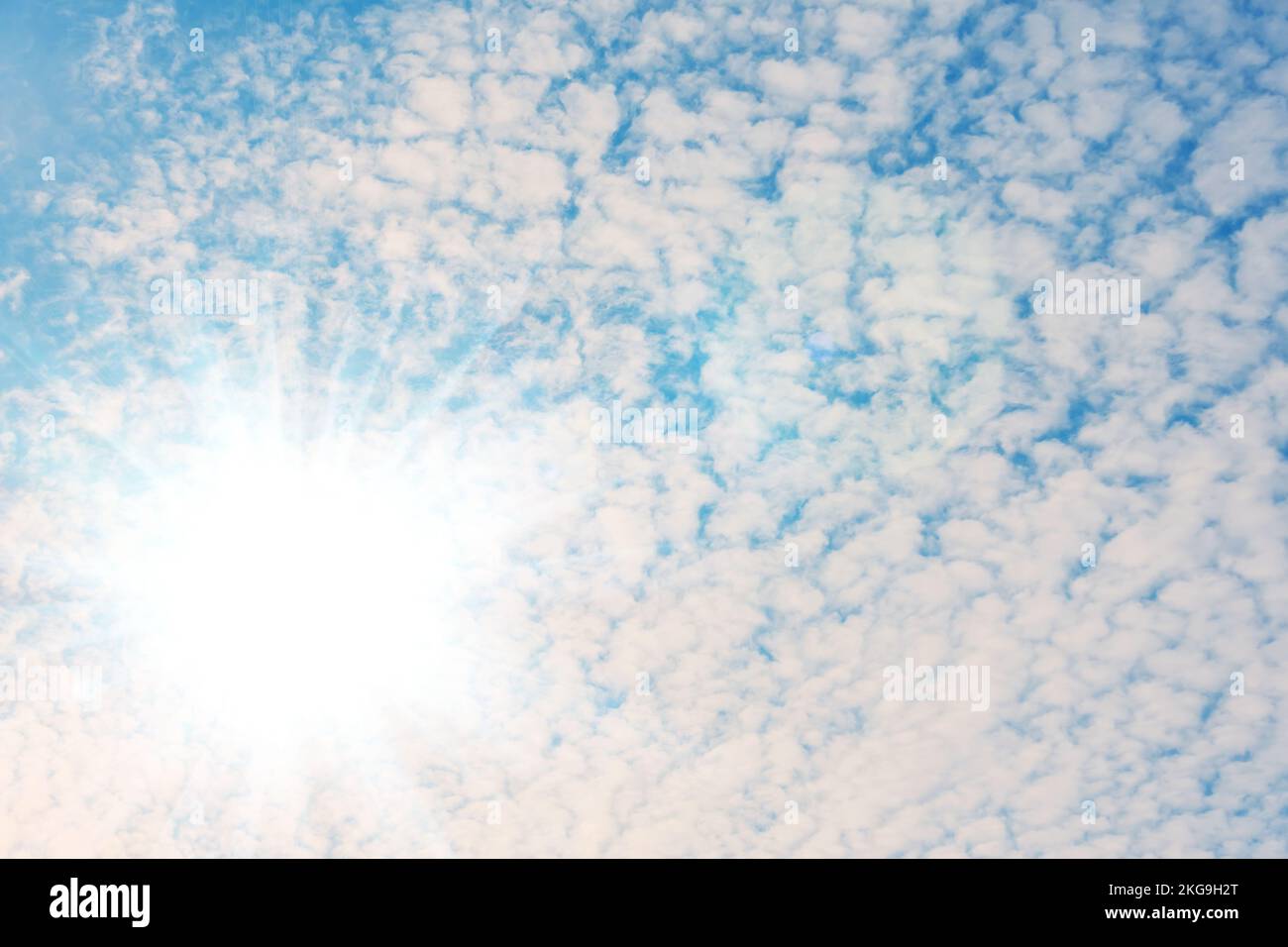 The sun with bright rays in the blue sky with white light clouds Stock ...