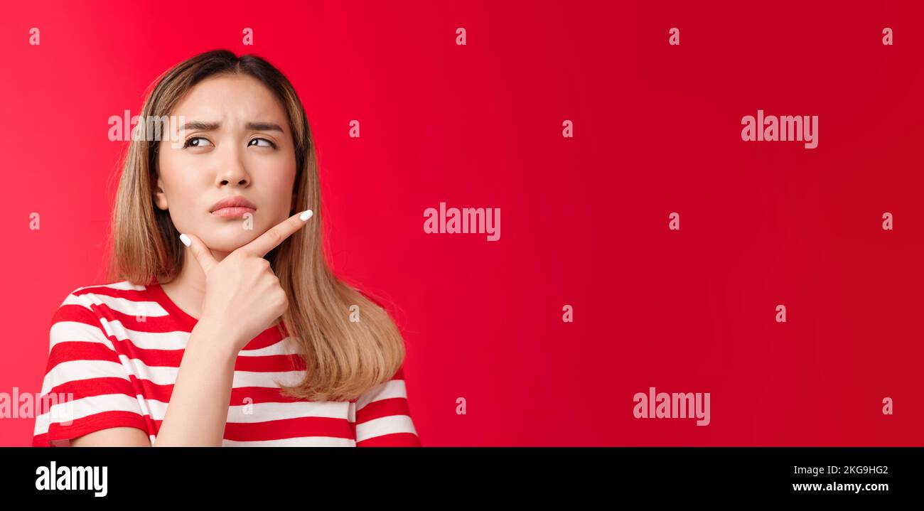 Close-up suspicious thoughtful girlfriend pondering, touch chin ...