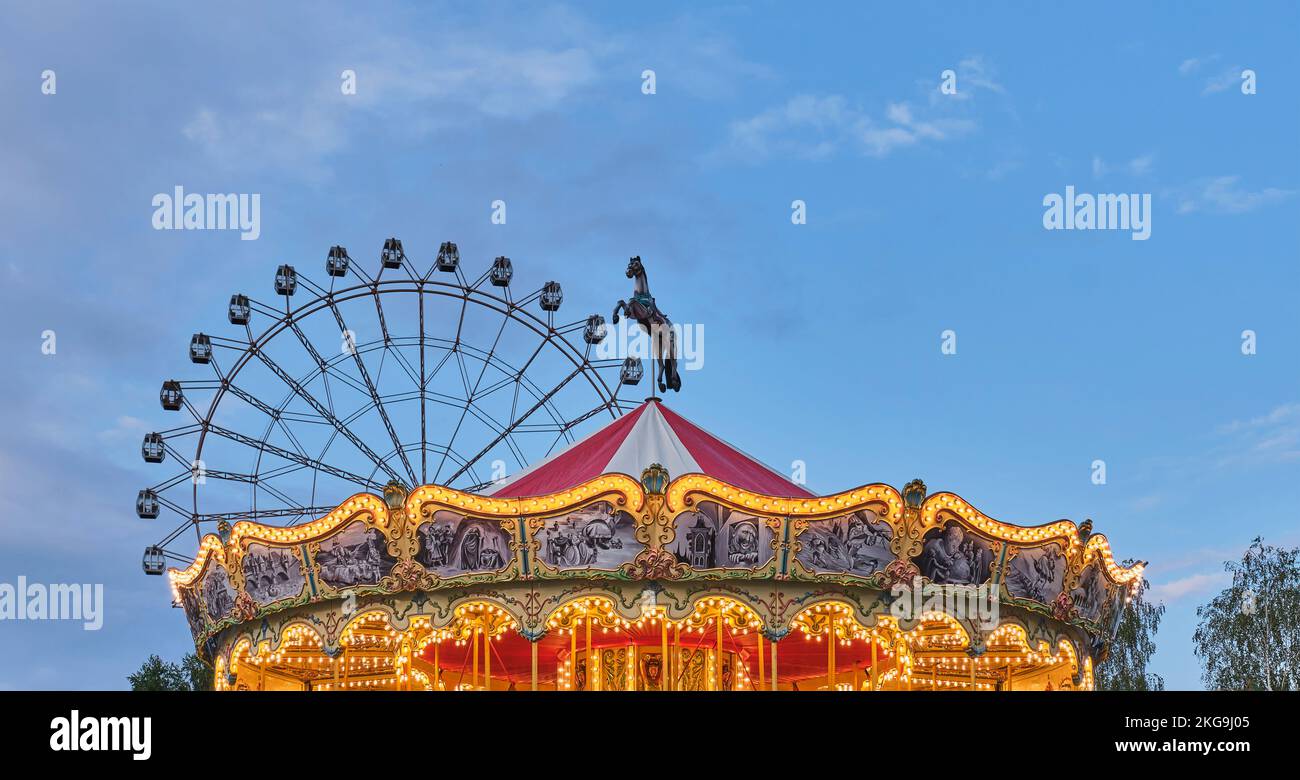 The dome of a children's carousel in a retro style, with lights, black ...