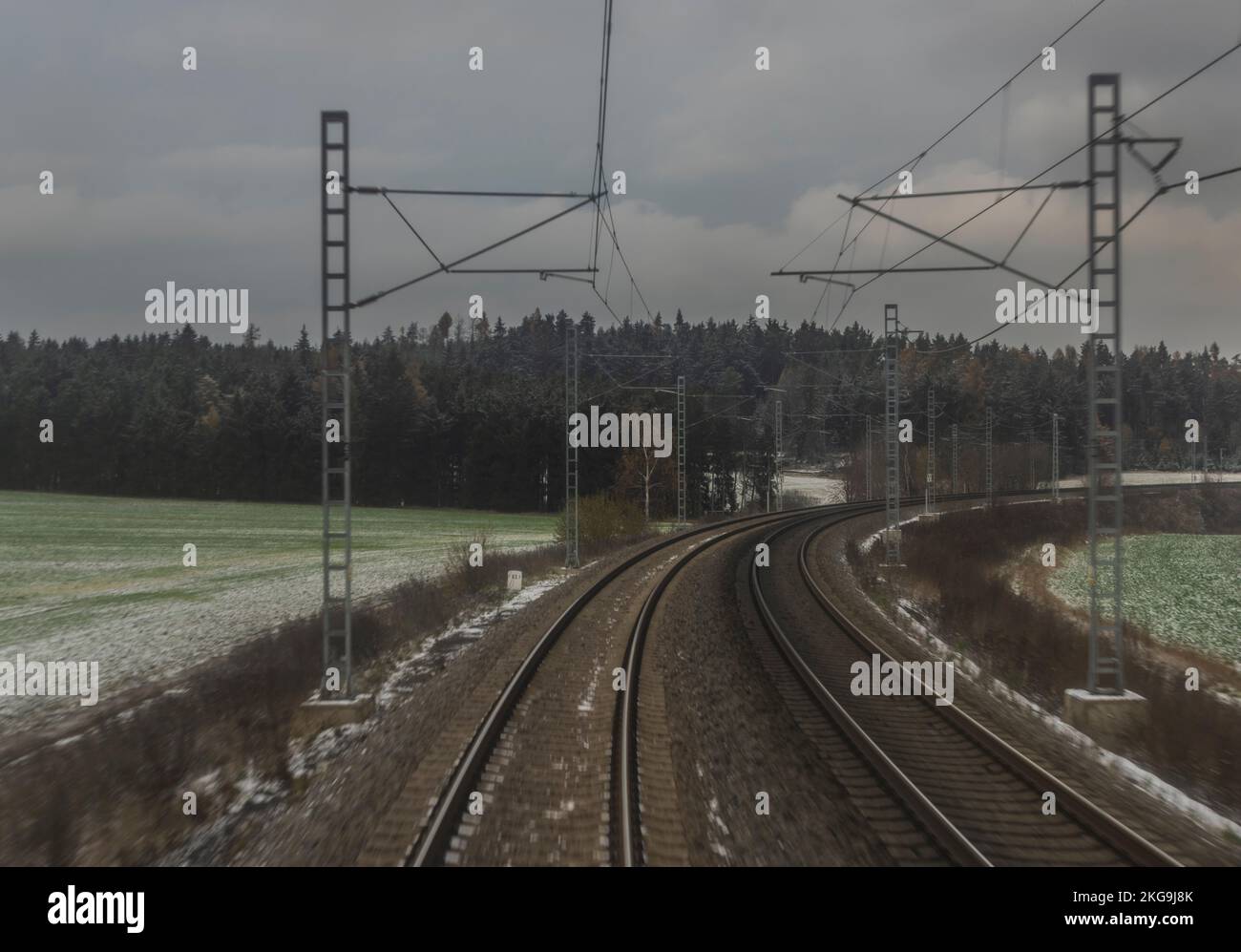 Electric railway track from window of end train in Vysocina mountains ...