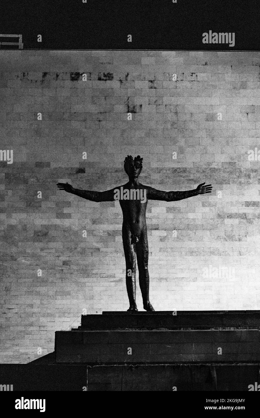 A vertical grayscale of a beautiful statue of a man in Kaunas ...