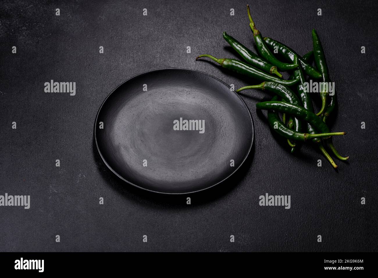 Hot pepper of green color on a dark concrete background. Mexican ...