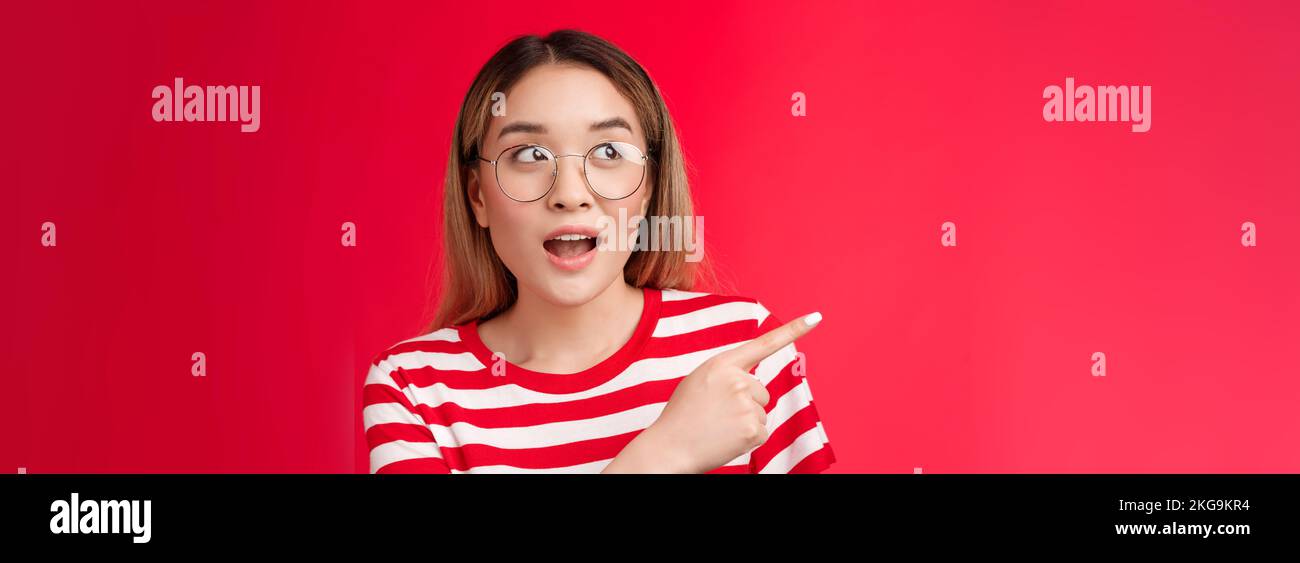 Amused wondered cute asian blond modern girl surprised, looking ...