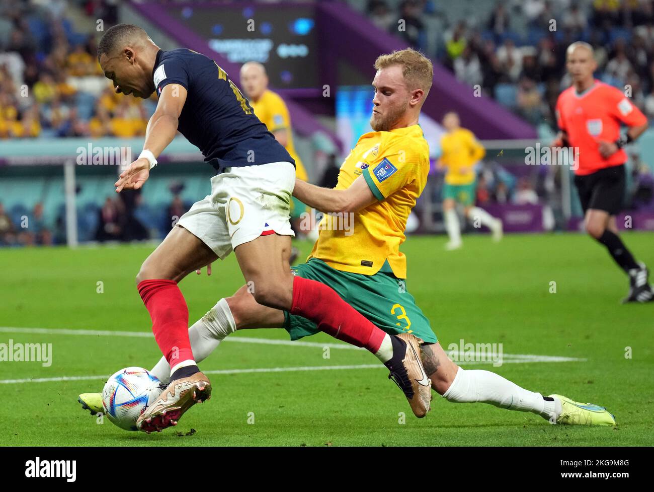 France's Kylian Mbappe tackled by Australia's Nathaniel Atkinson during ...
