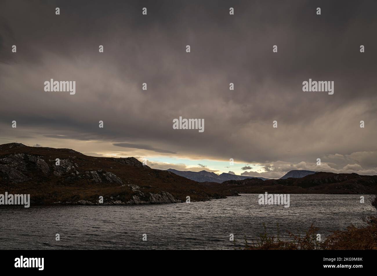 A gloomy autumnal HDR image of loch nam brac on the road to Tarbet with Foinaven and Arkle in ...