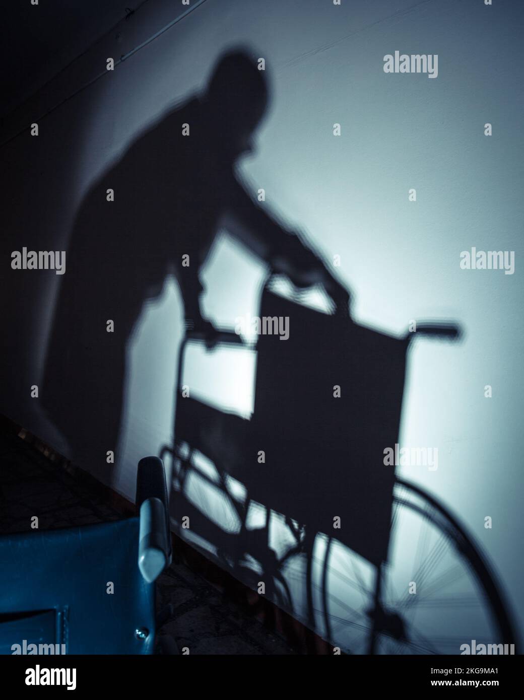 Sick people and wheelchair, shadow on the wall Stock Photo - Alamy
