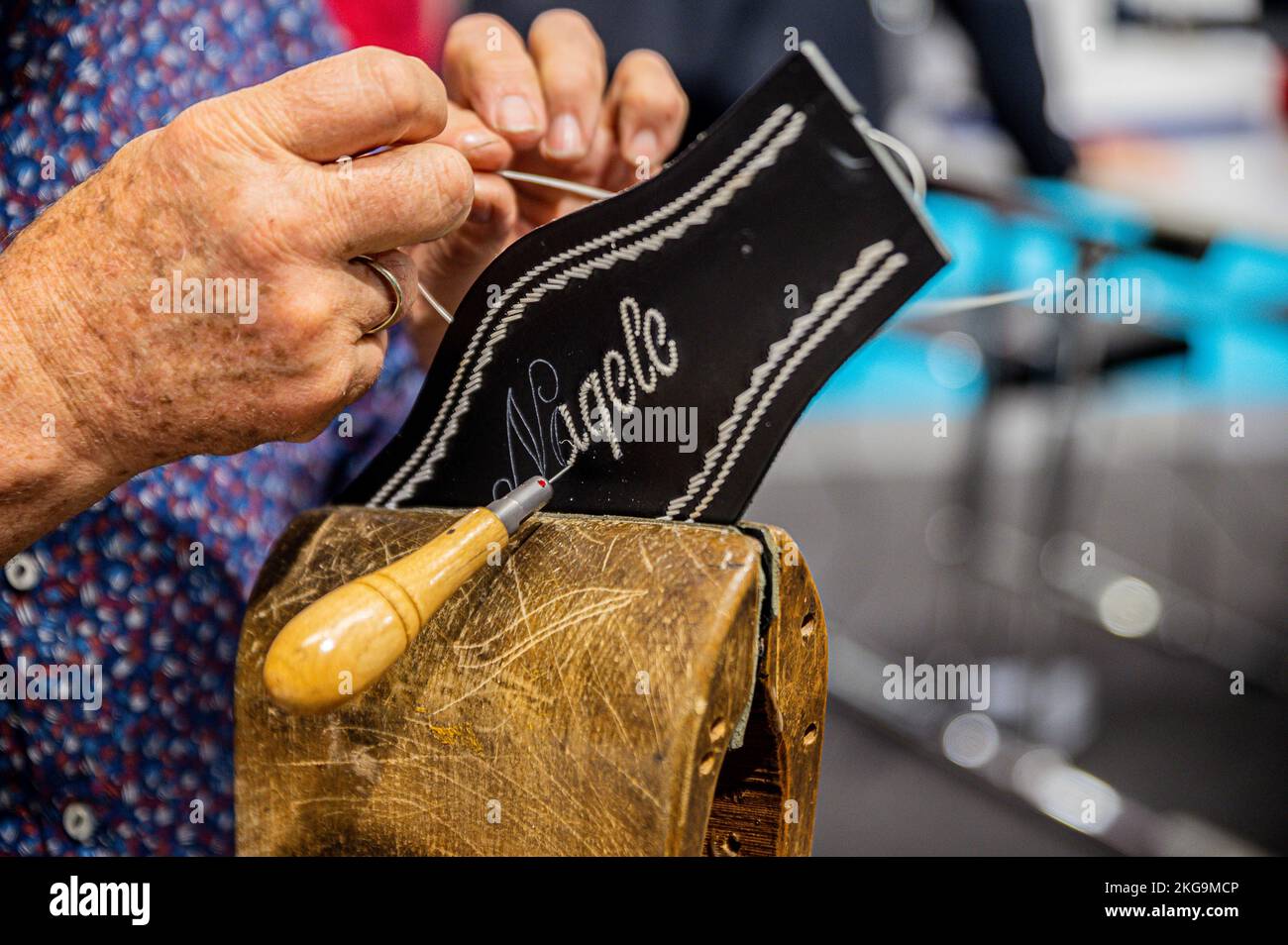 An embroiderer doing needlework on a traditional leather belt Stock ...