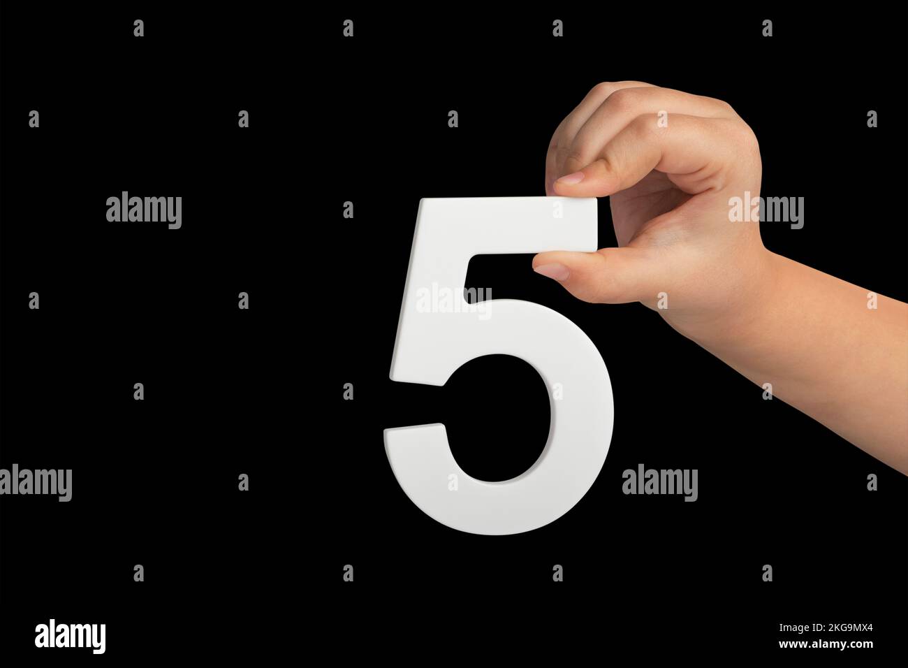 Number five in hand isolated on black background. Number five in the ...